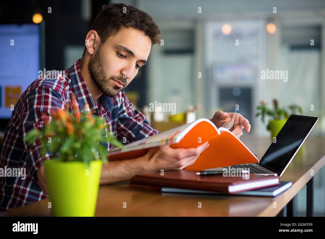 Handsome student studying in restaurant Stock Photo - Alamy