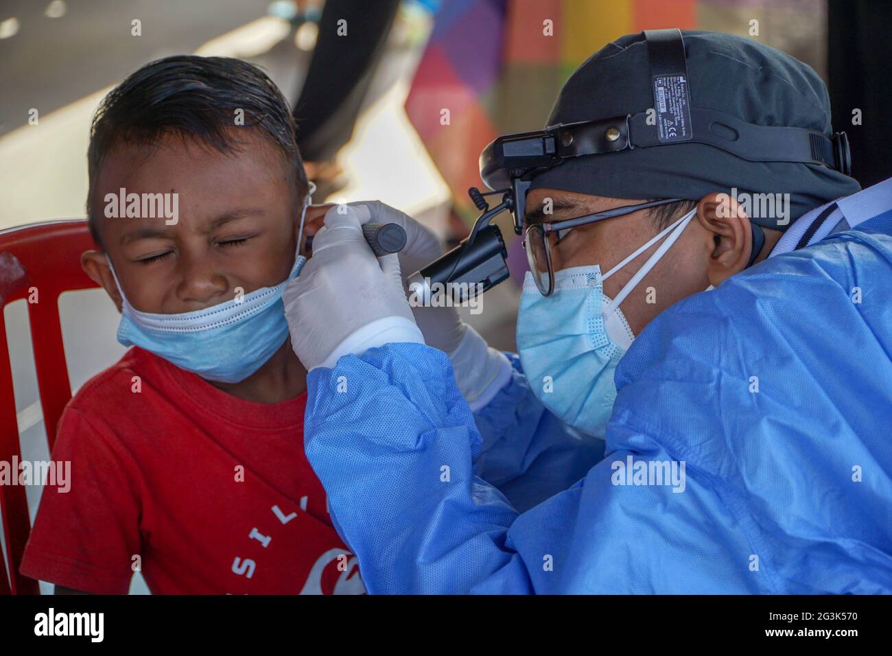 BALI/INDONESIA-MAY 28 2021: An ENT doctor is examining the ears, nose ...