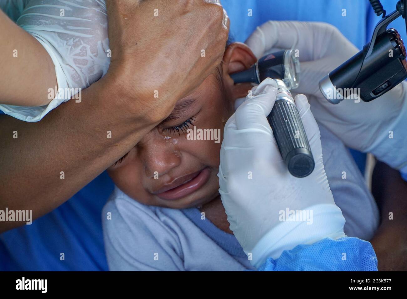 BALI/INDONESIA-MAY 28 2021: An ENT doctor is examining the ears, nose ...