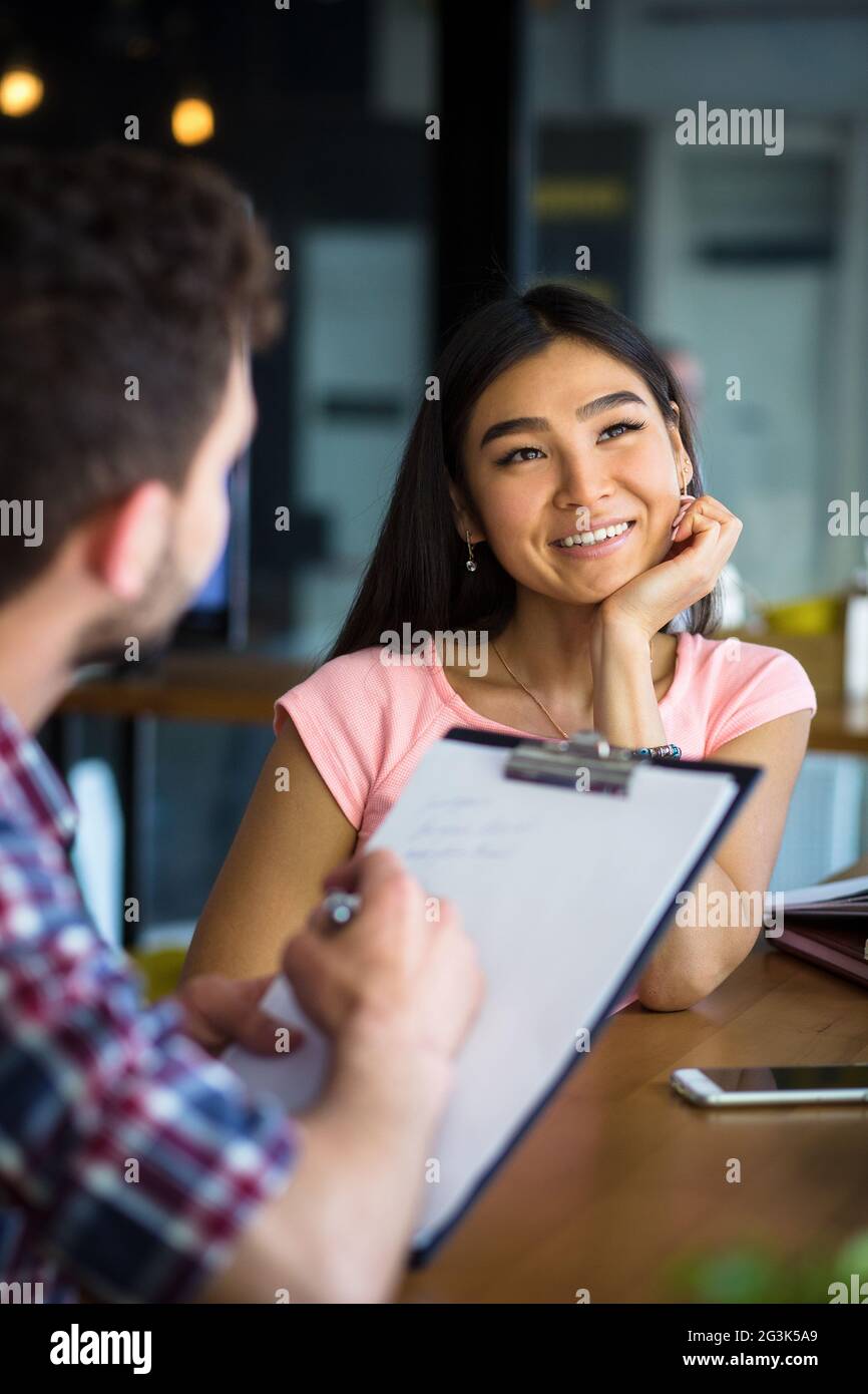 Beautiful lady having interview in restaurant Stock Photo - Alamy