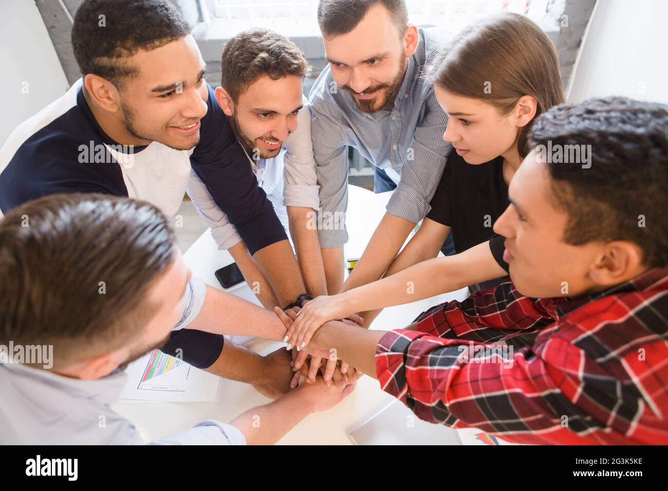 Business people showing teamwork in office Stock Photo - Alamy