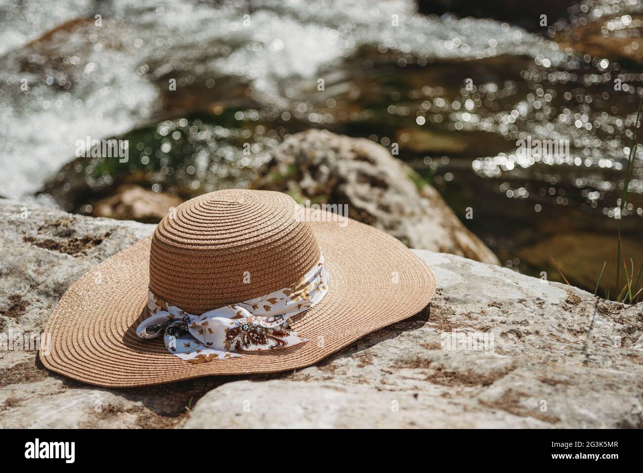 hat on the rocks by the river Stock Photo - Alamy
