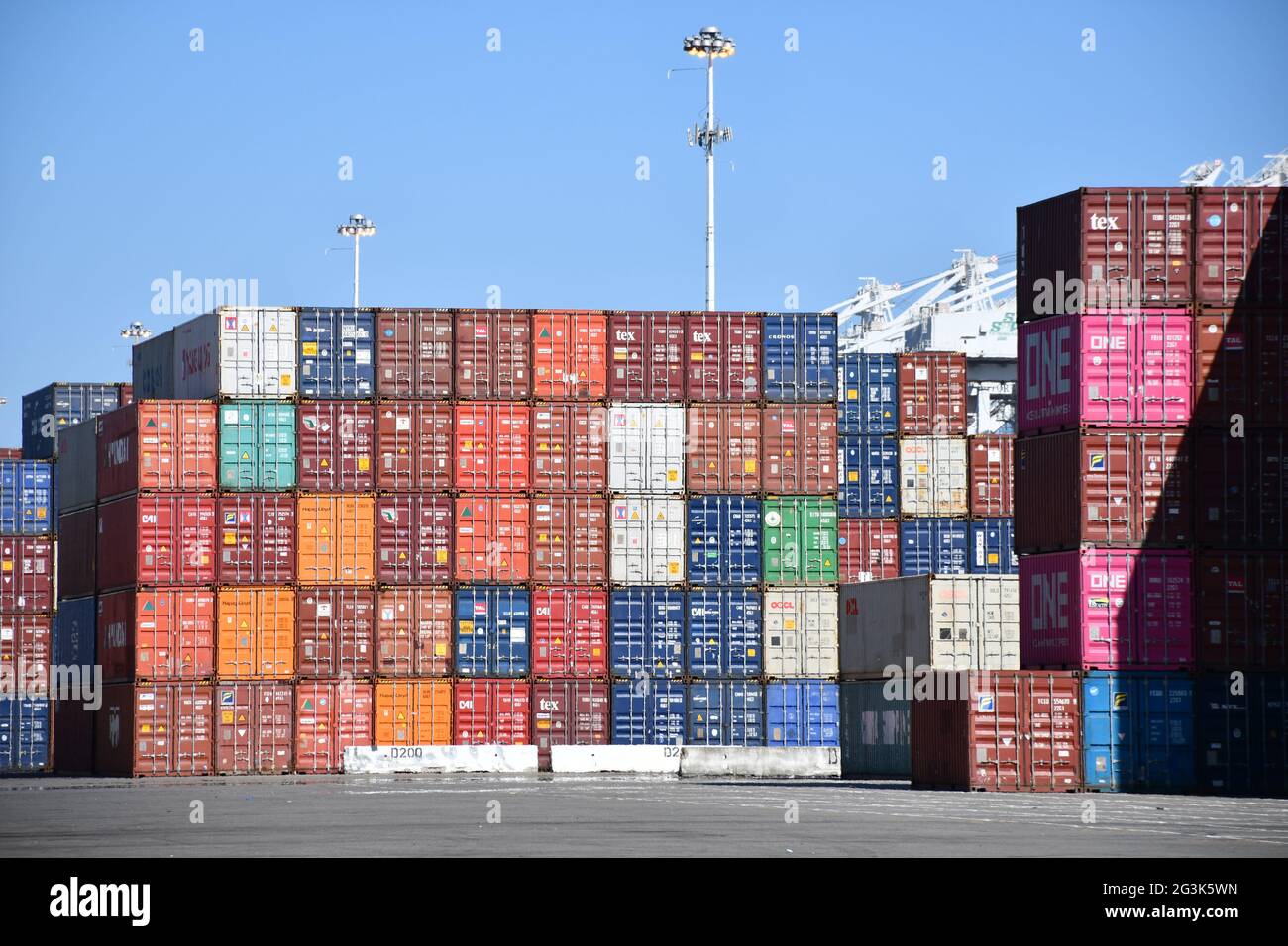 Shipping containers are loaded onto ships at the Port of Oakland ...