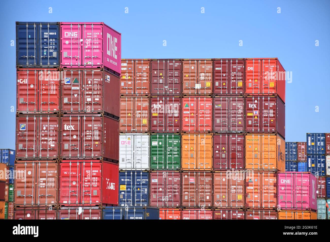 Shipping containers are loaded onto ships at the Port of Oakland ...