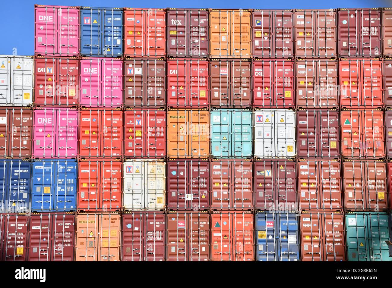 Shipping containers are loaded onto ships at the Port of Oakland ...