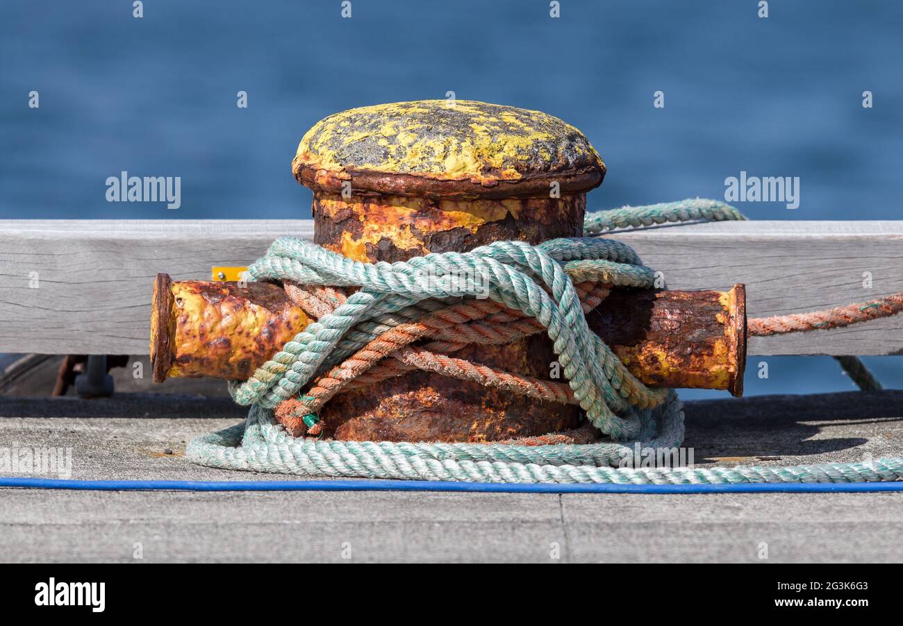 Metal bollard with ropes Stock Photo - Alamy