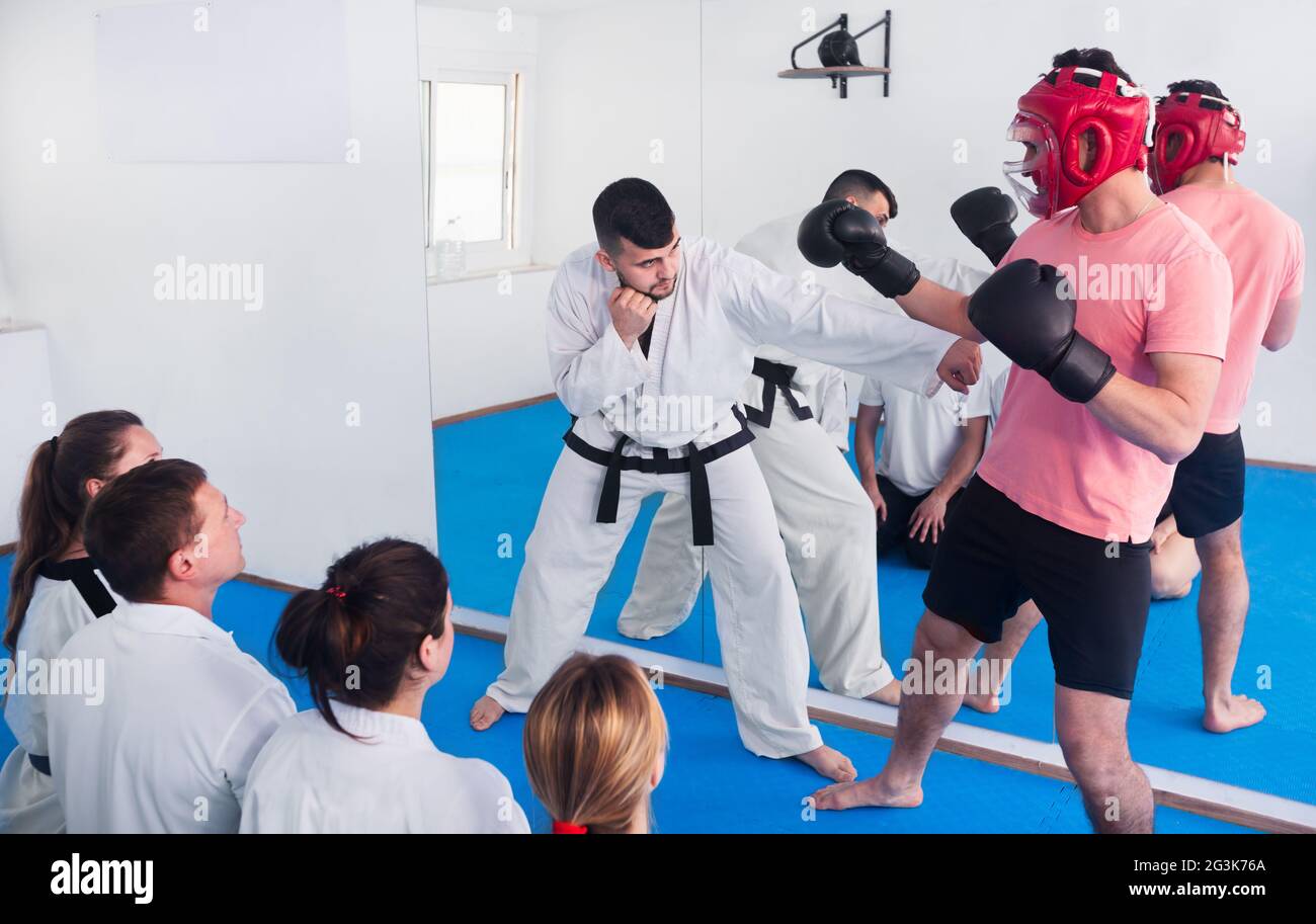 Young adult trainees practicing in karate class Stock Photo - Alamy