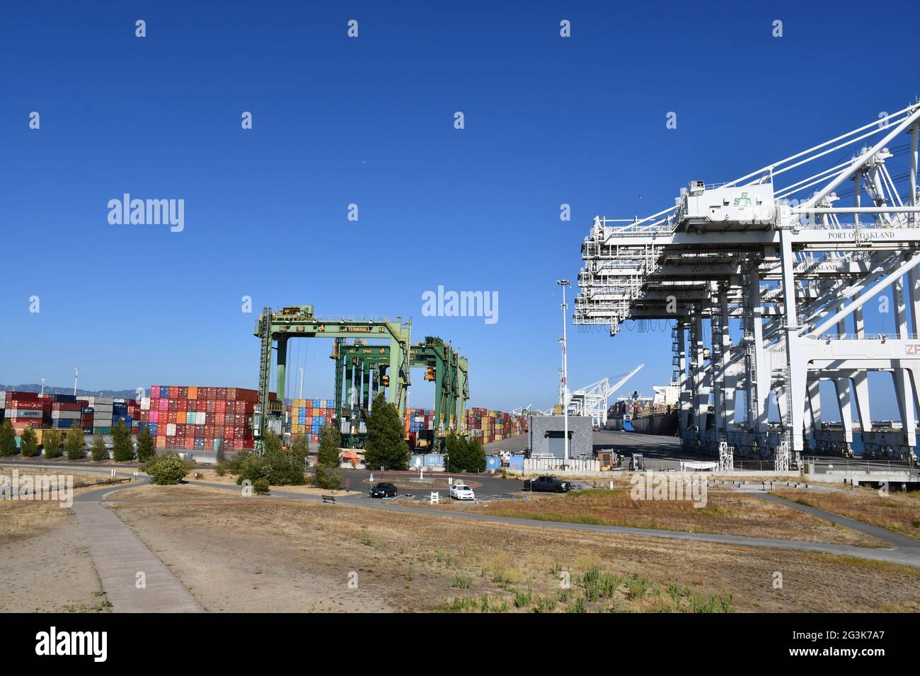 Shipping containers are loaded onto ships at the Port of Oakland ...