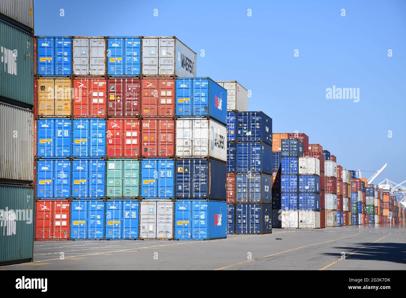 Shipping containers are loaded onto ships at the Port of Oakland ...