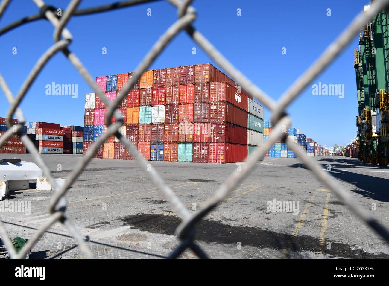 Shipping containers are loaded onto ships at the Port of Oakland ...