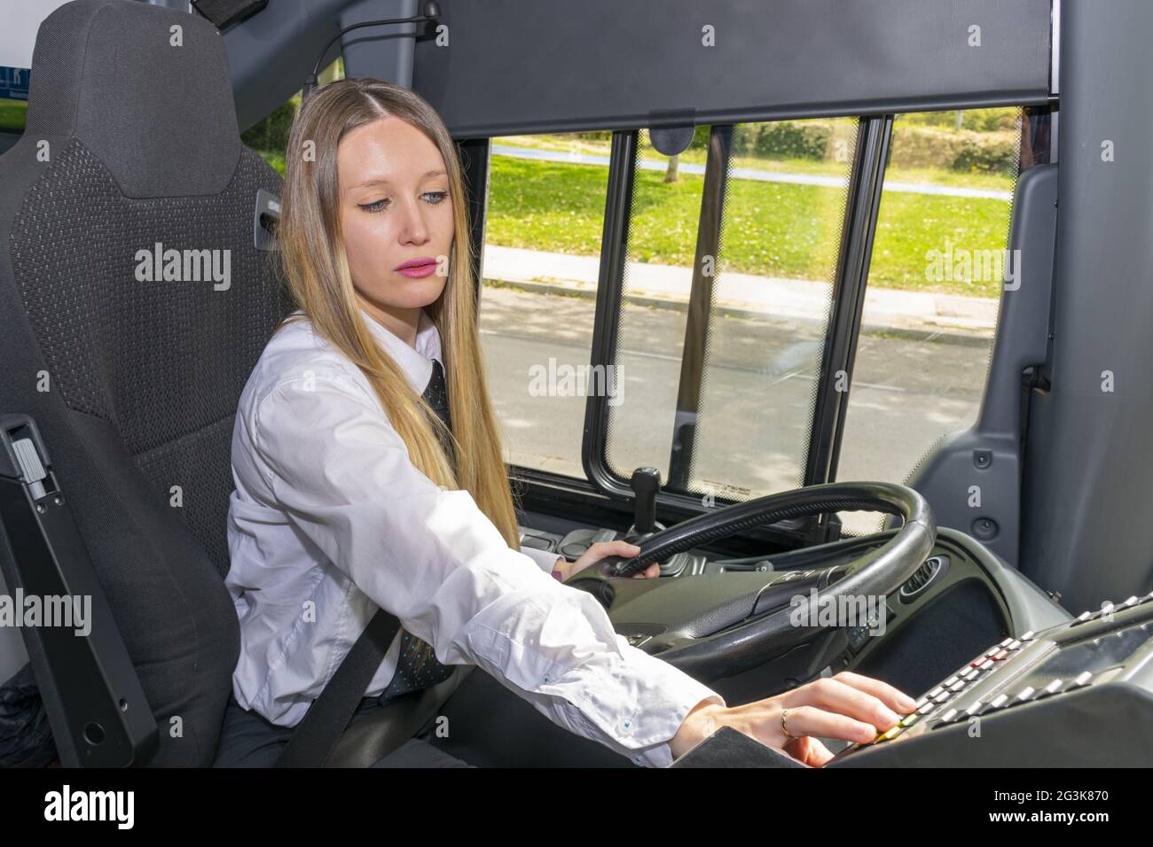 Pretty young female bus driver using the PSO to collect bus fare from a ...