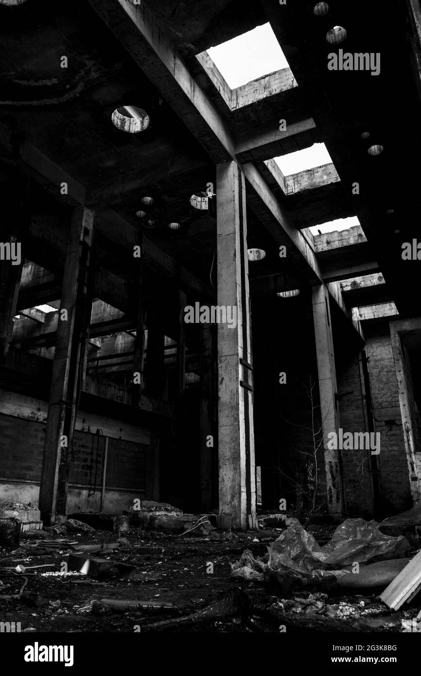 Vertical grayscale shot of the inside of an old destroyed building ...