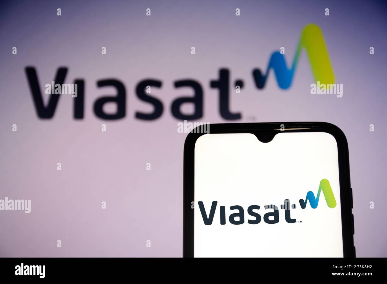 In this photo illustration, a Viasat Inc. logo seen displayed on a ...