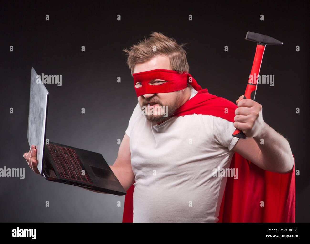 Super hero man with laptop computer Stock Photo - Alamy