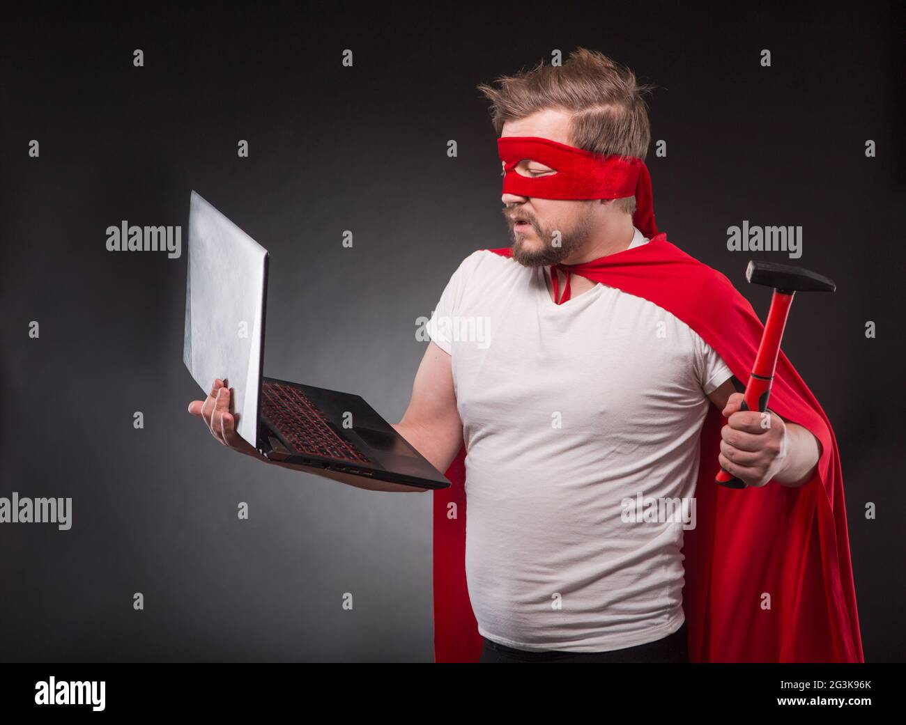Super hero man with laptop computer Stock Photo - Alamy