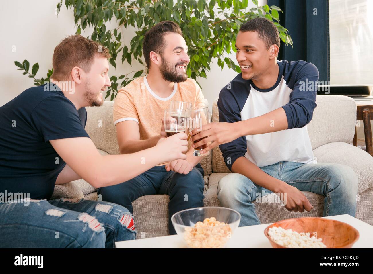 Happy friends drinking beer at home Stock Photo - Alamy