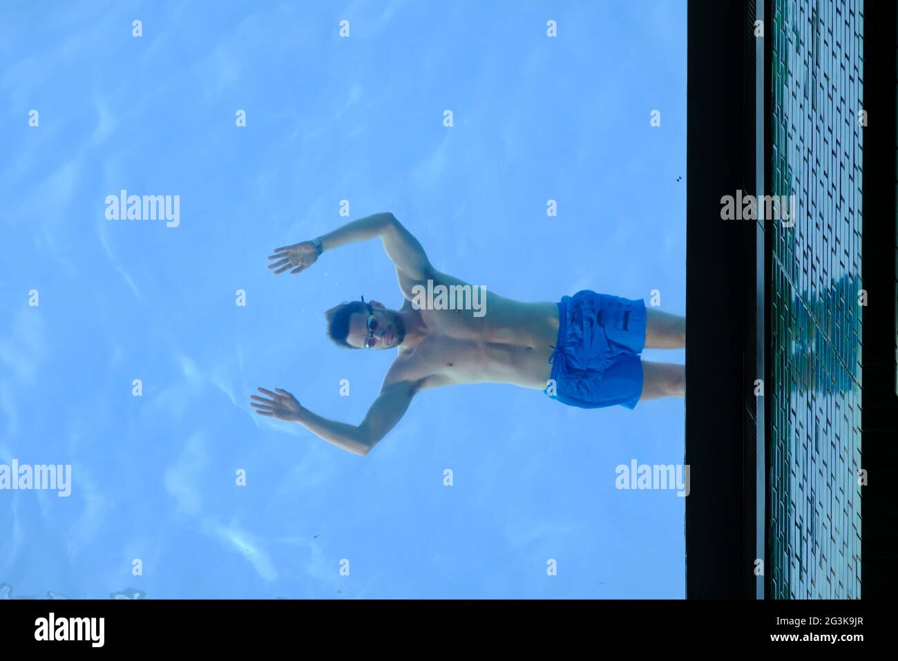 London, UK. A swimmer looks down through the bottom of the newly-opened ...