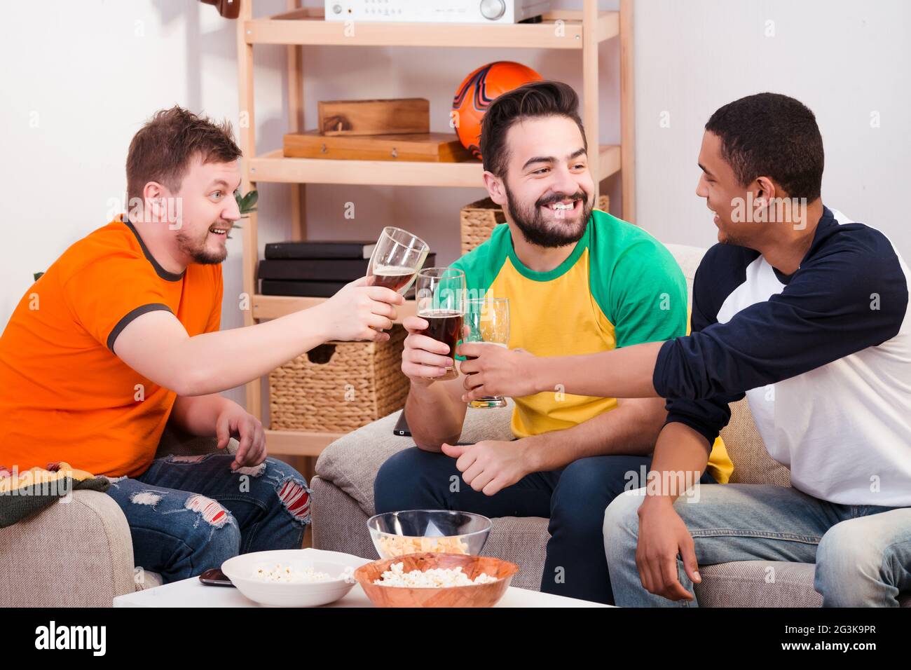 Happy friends drinking beer at home Stock Photo - Alamy