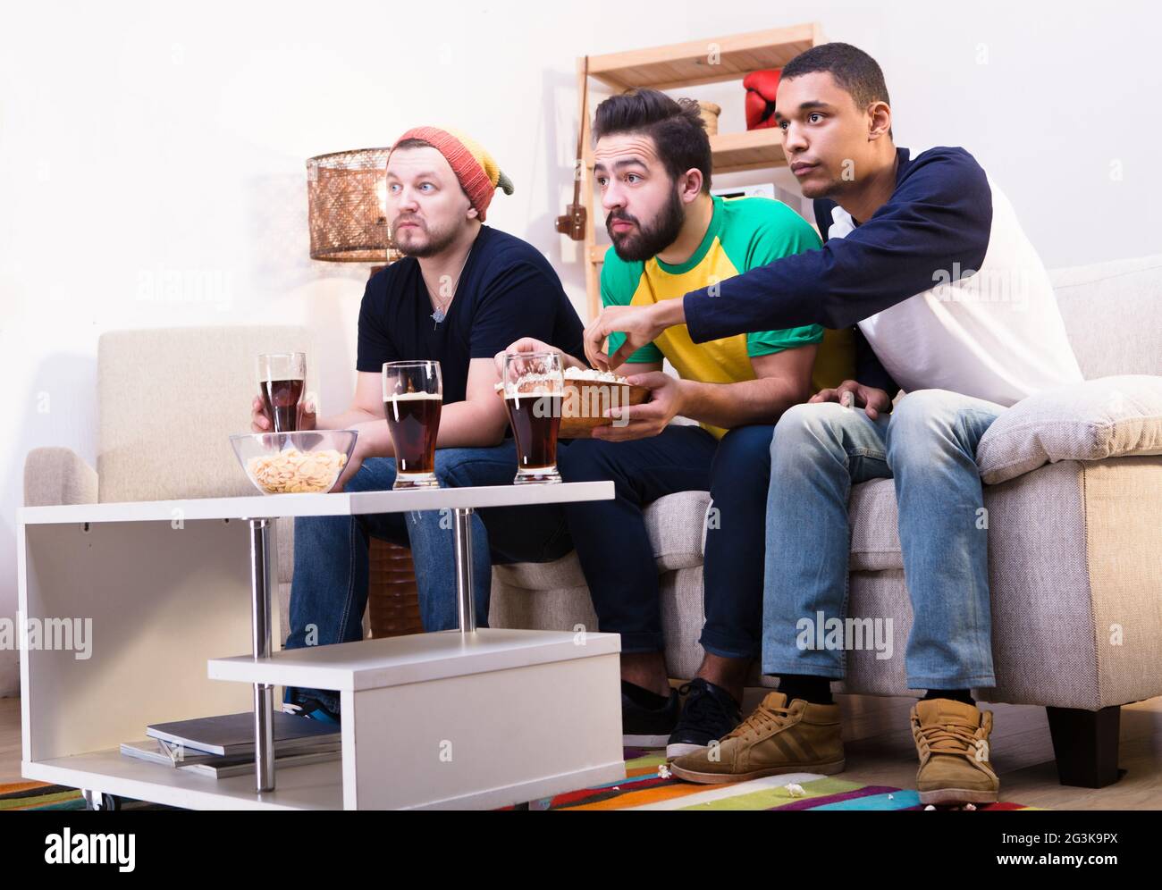 Group watching football tv indoors hi-res stock photography and images ...