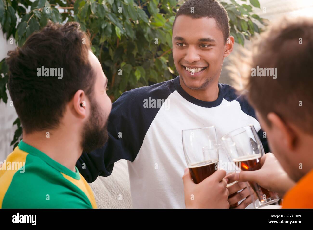 Happy friends drinking beer at home Stock Photo - Alamy