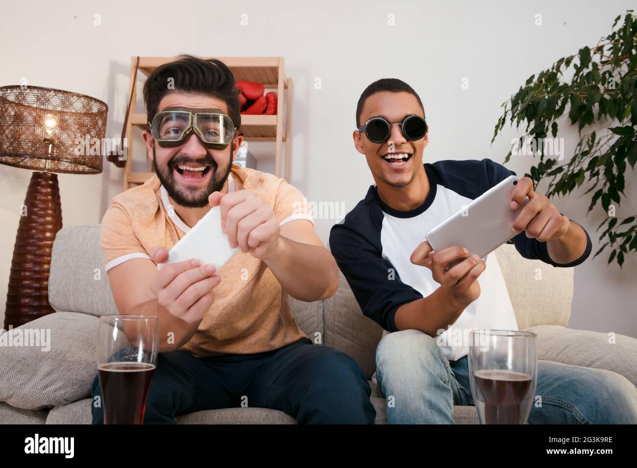 Happy friends playing computer games Stock Photo - Alamy