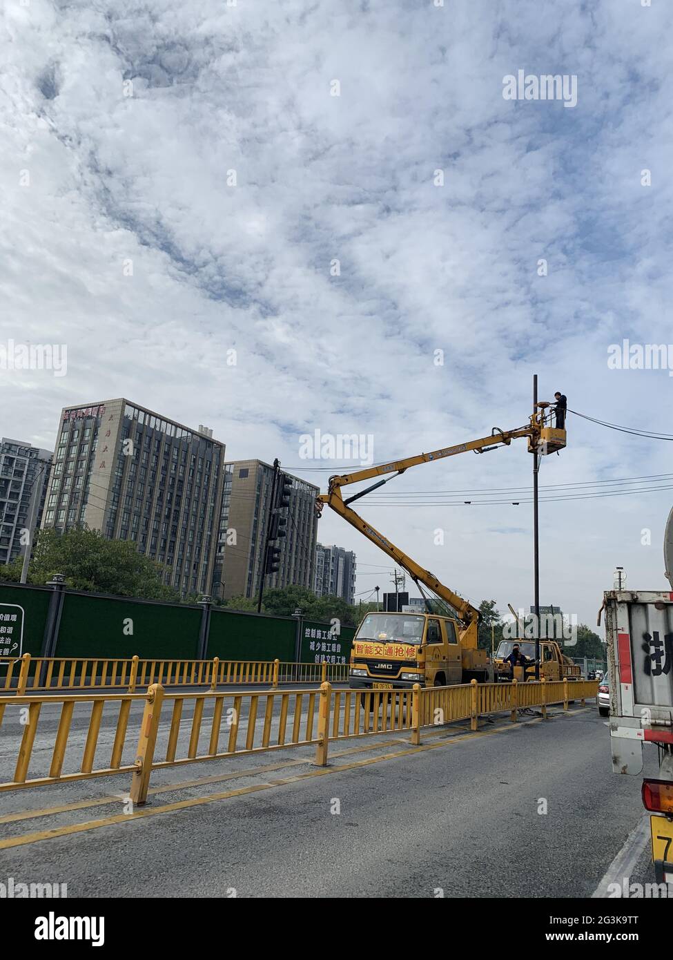 Worker fixing the power lines while standing on the mobile elevating ...