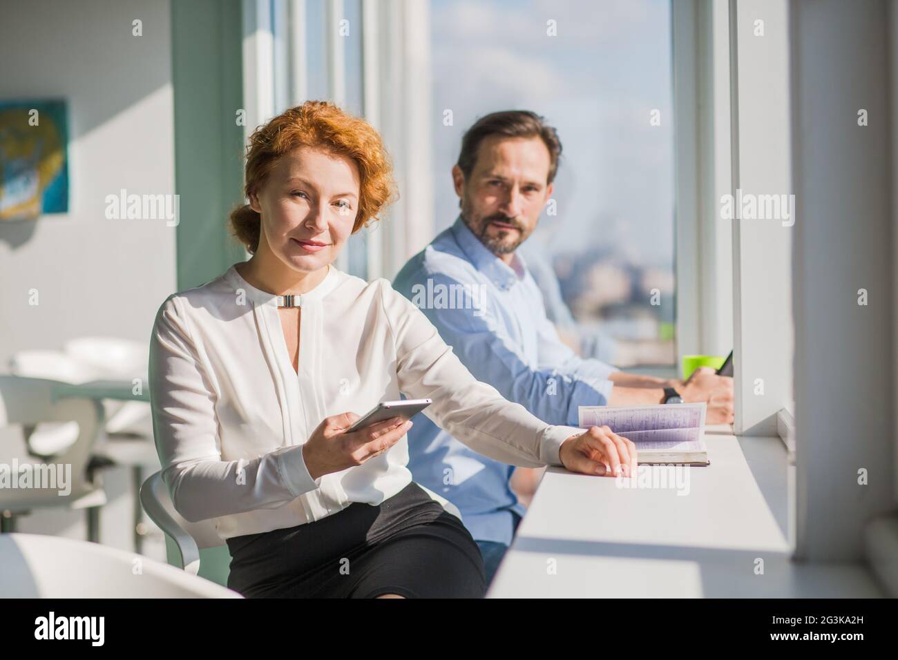 Business people having break during work in office interior Stock Photo ...