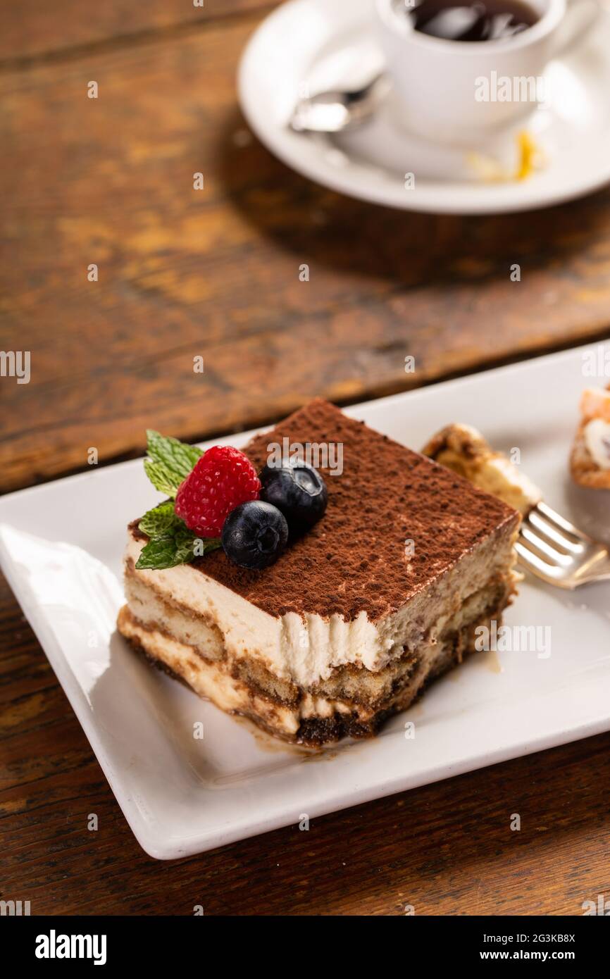Traditional italian desserts, tiramisu and cannoli on the plate Stock ...