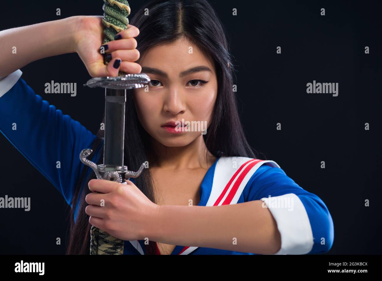 Asian lady with sword in studio Stock Photo - Alamy