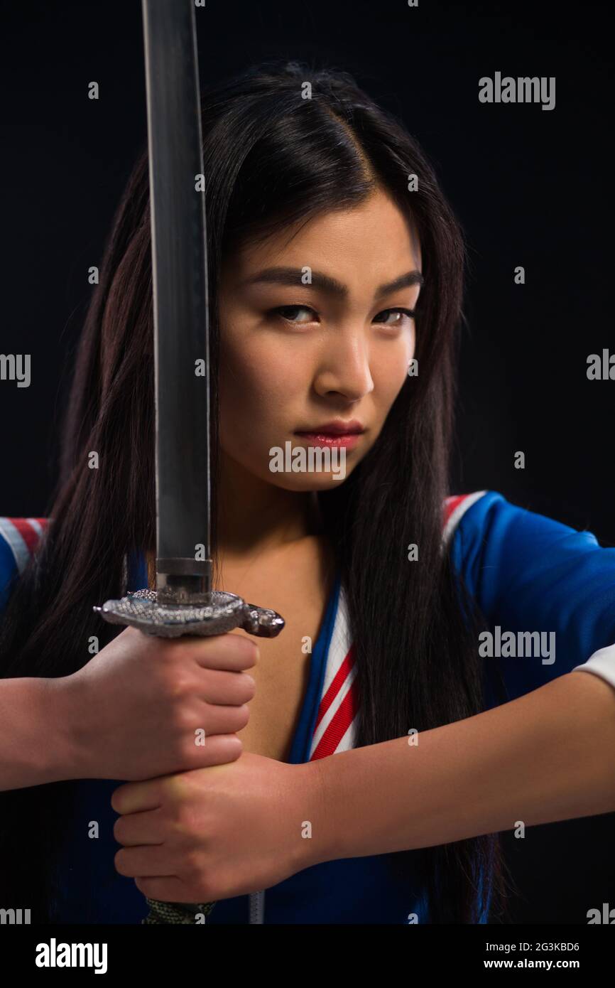 Asian lady with sword in studio Stock Photo - Alamy