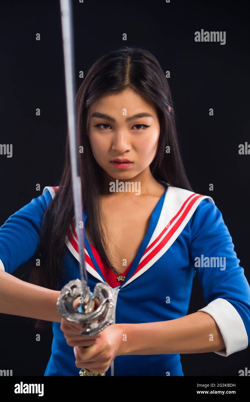 Asian lady with sword in studio Stock Photo - Alamy