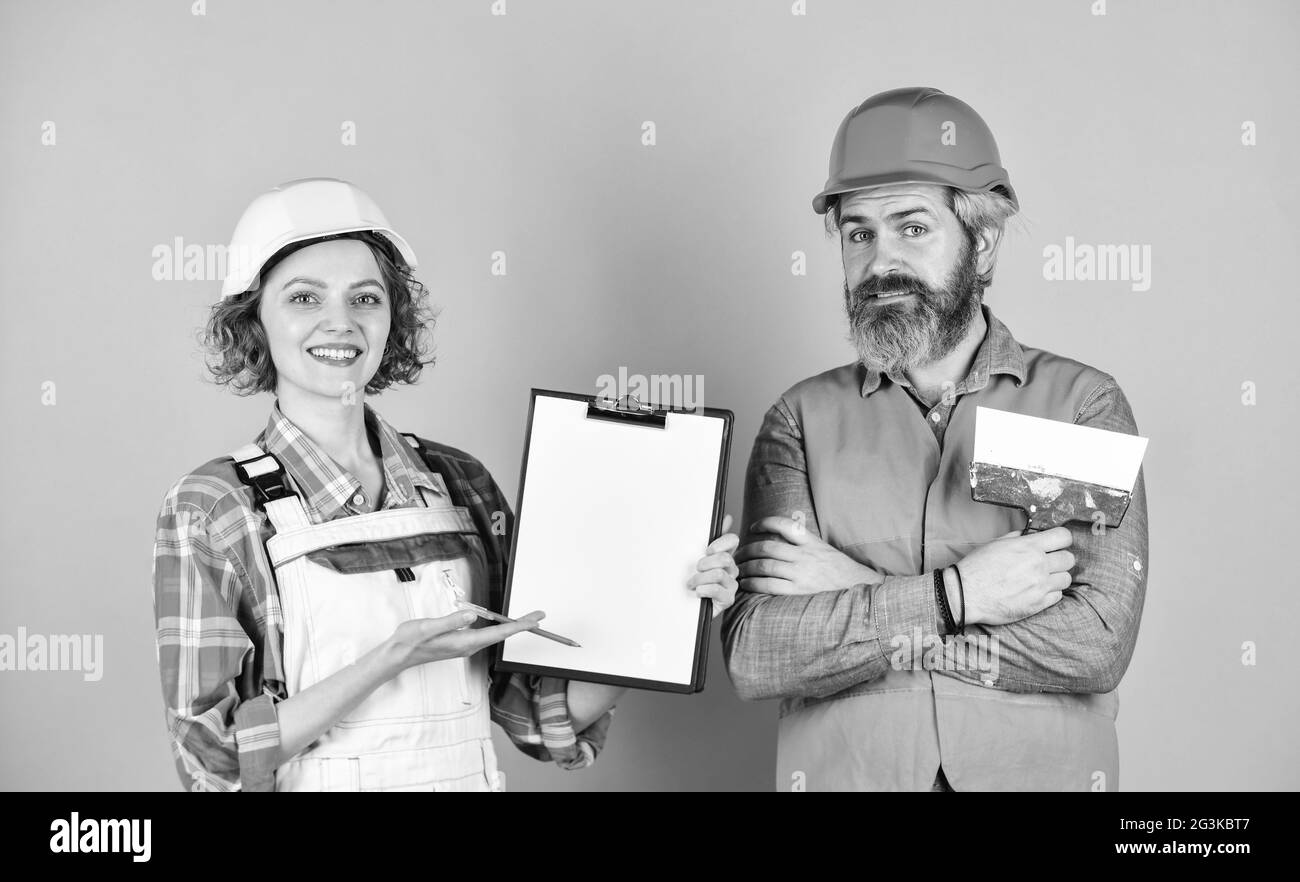 family standing inside house under construction. renovation and people ...