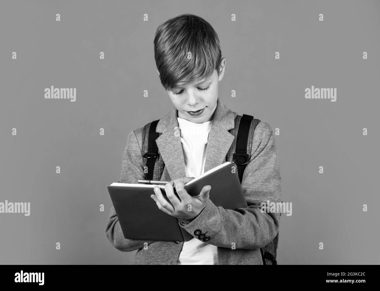 Practice makes perfect. Small child do homework. Little boy write in ...