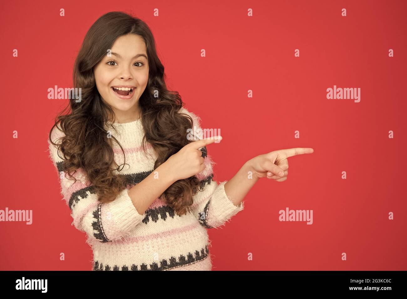 This way. Direction indicator. Happy girl pointing at red background ...