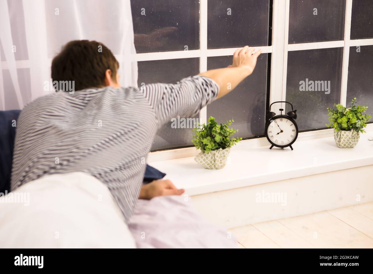 Man with clock hi-res stock photography and images - Alamy