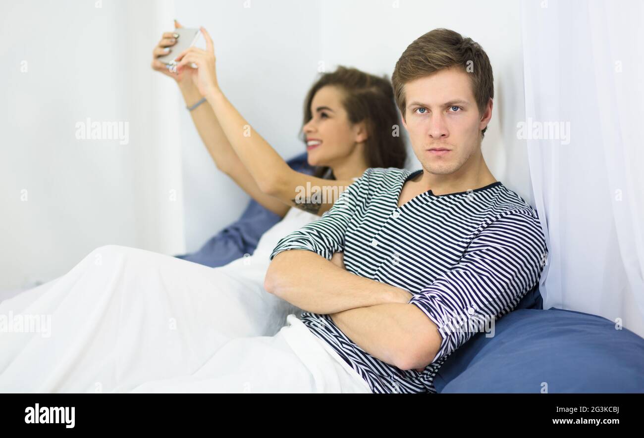 Couple using mobile phone in bed Stock Photo - Alamy