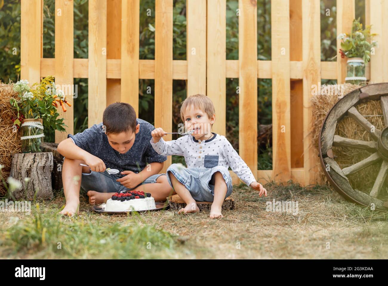 Two cute boys happily eating healthy food outdoors. Adventure time ...