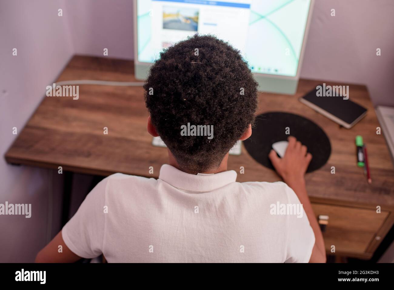 Young boy doing work from home Stock Photo - Alamy