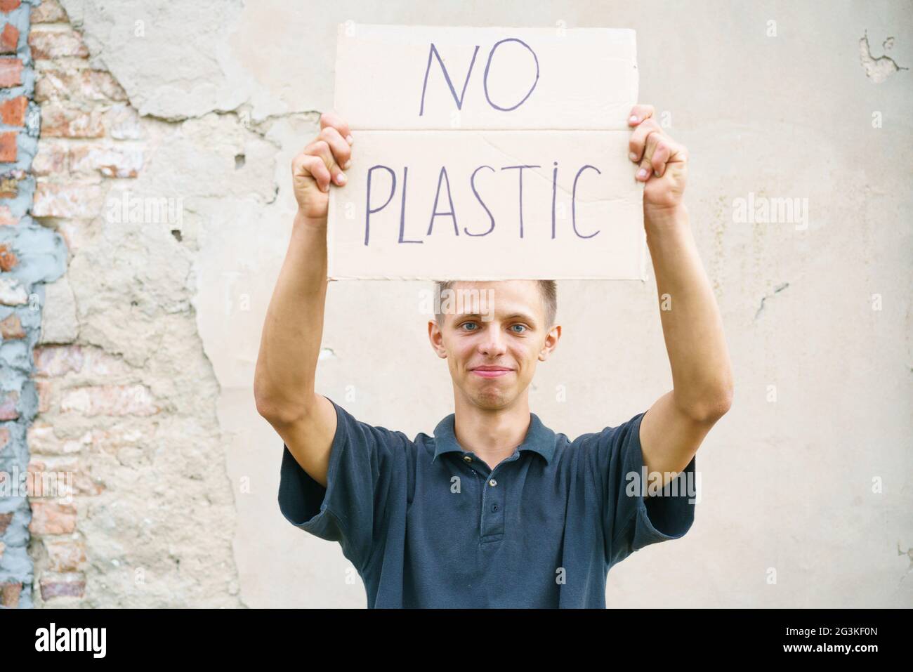 Caucasian guy holding the inscription no plastic. Environmental ...