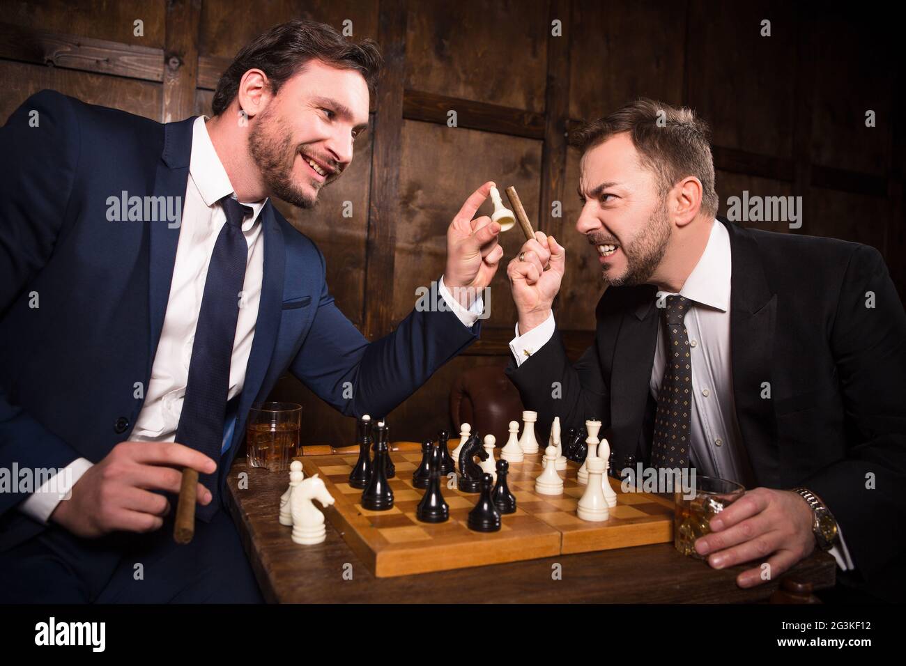 Rich businessmen playing chess Stock Photo - Alamy