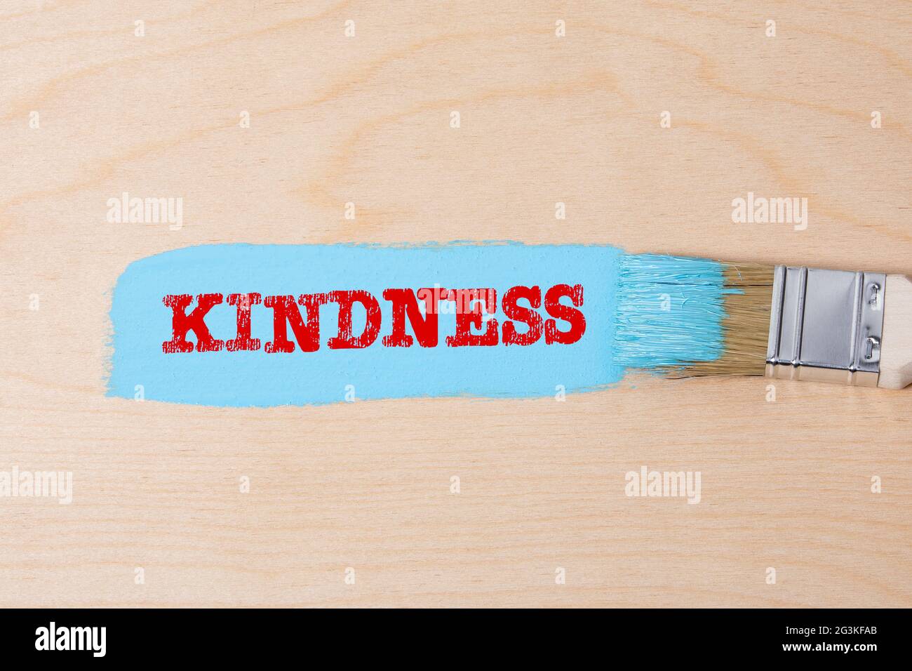 Kindness. Blue color and a brush on a plywood background Stock Photo ...