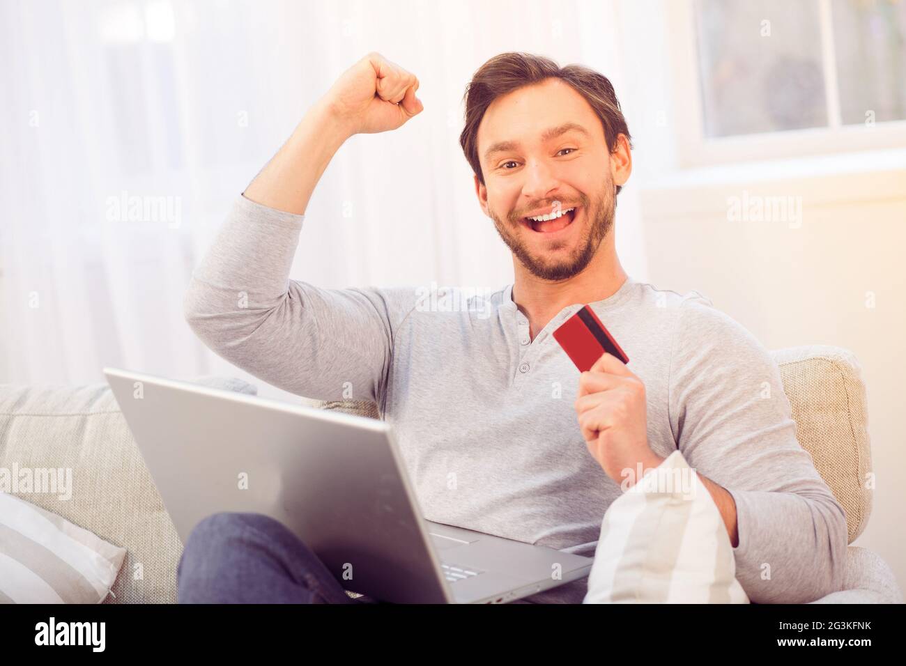 Handsome man with laptop and credit card Stock Photo - Alamy