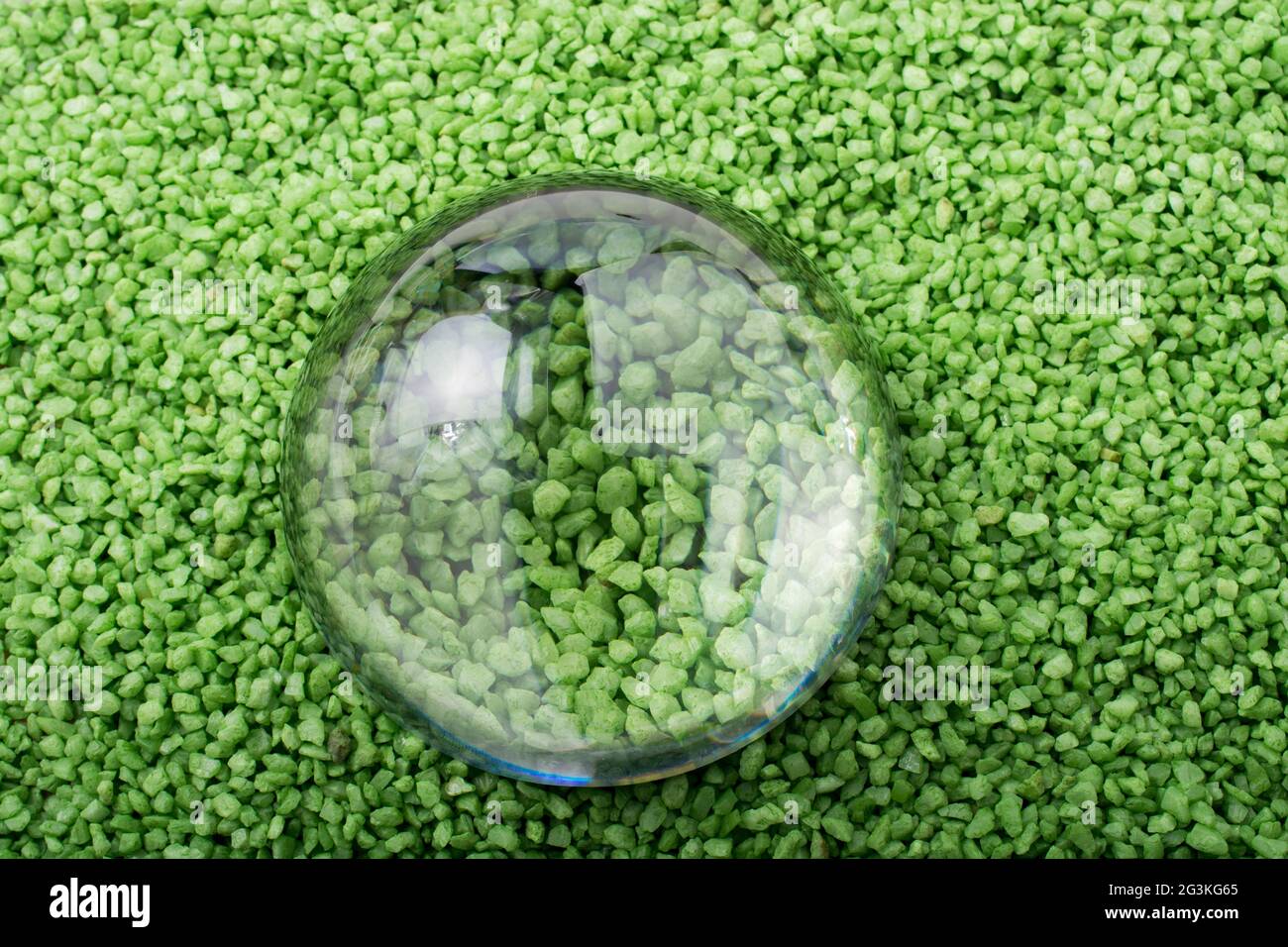 Closeup shot of a crystal ball on green pebbles background Stock Photo ...
