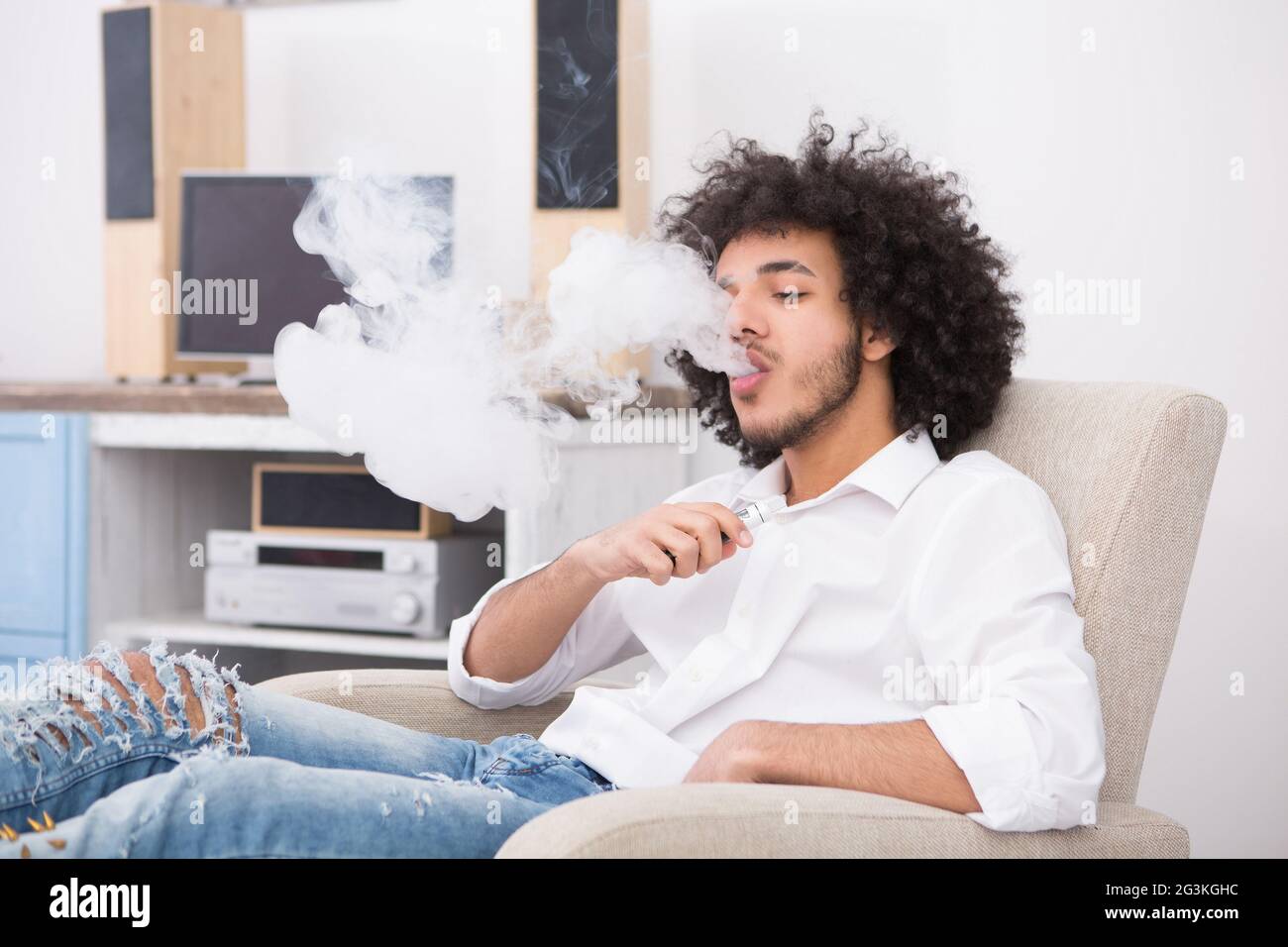 Hipster man smoking at home Stock Photo - Alamy