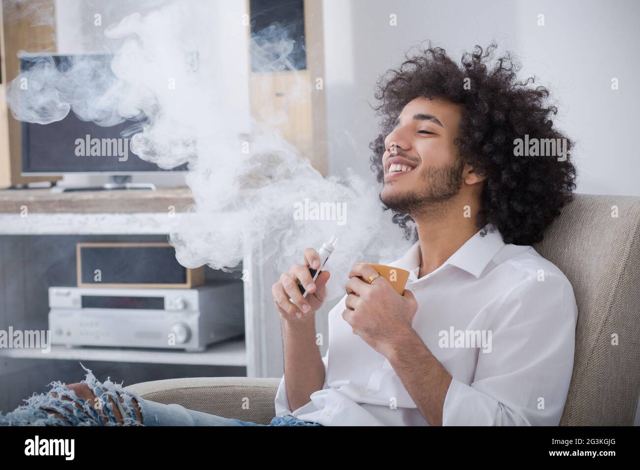 Hipster man smoking at home Stock Photo - Alamy