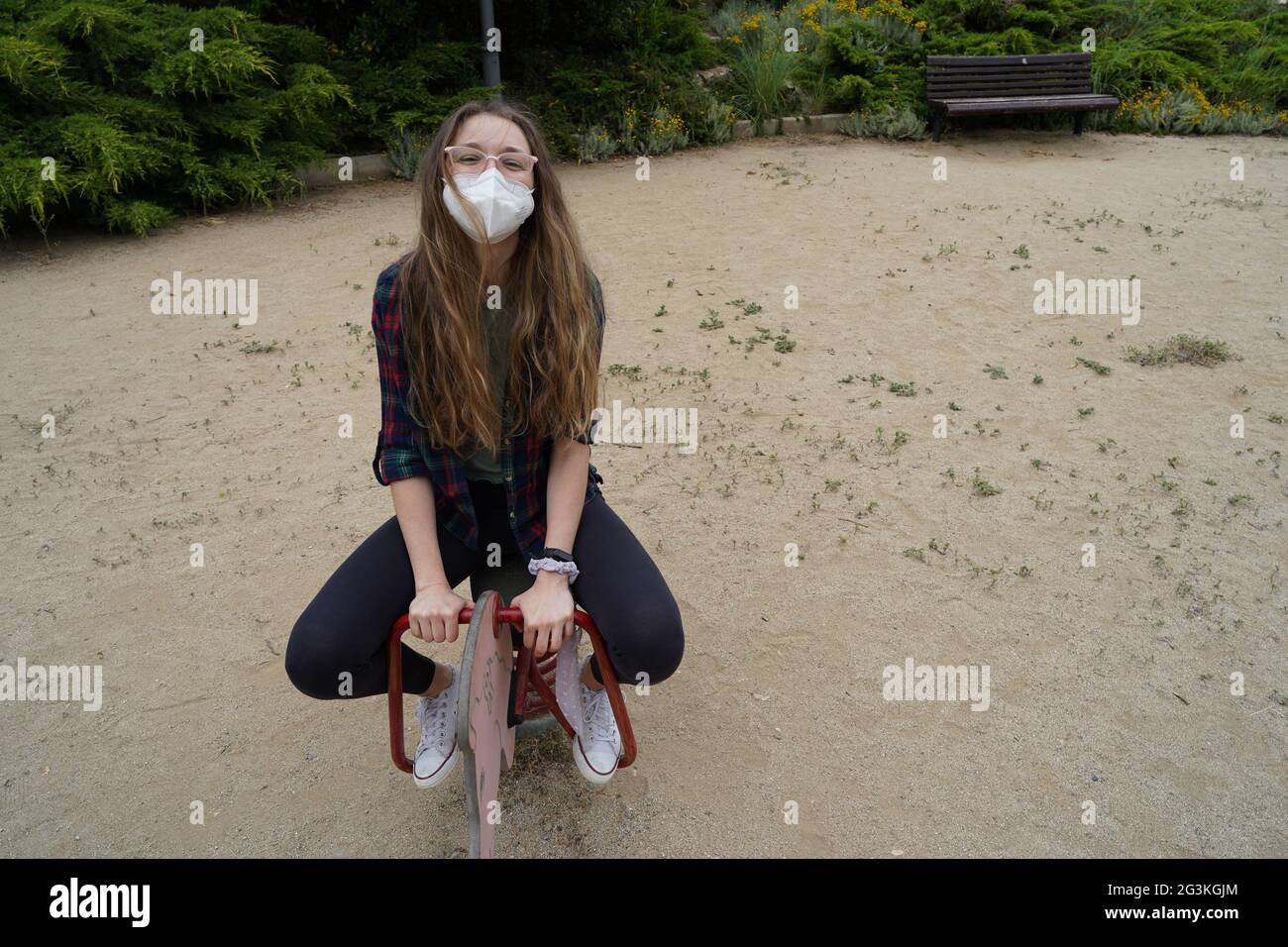 Caucasian female with a medical face mask in a playground Stock Photo ...