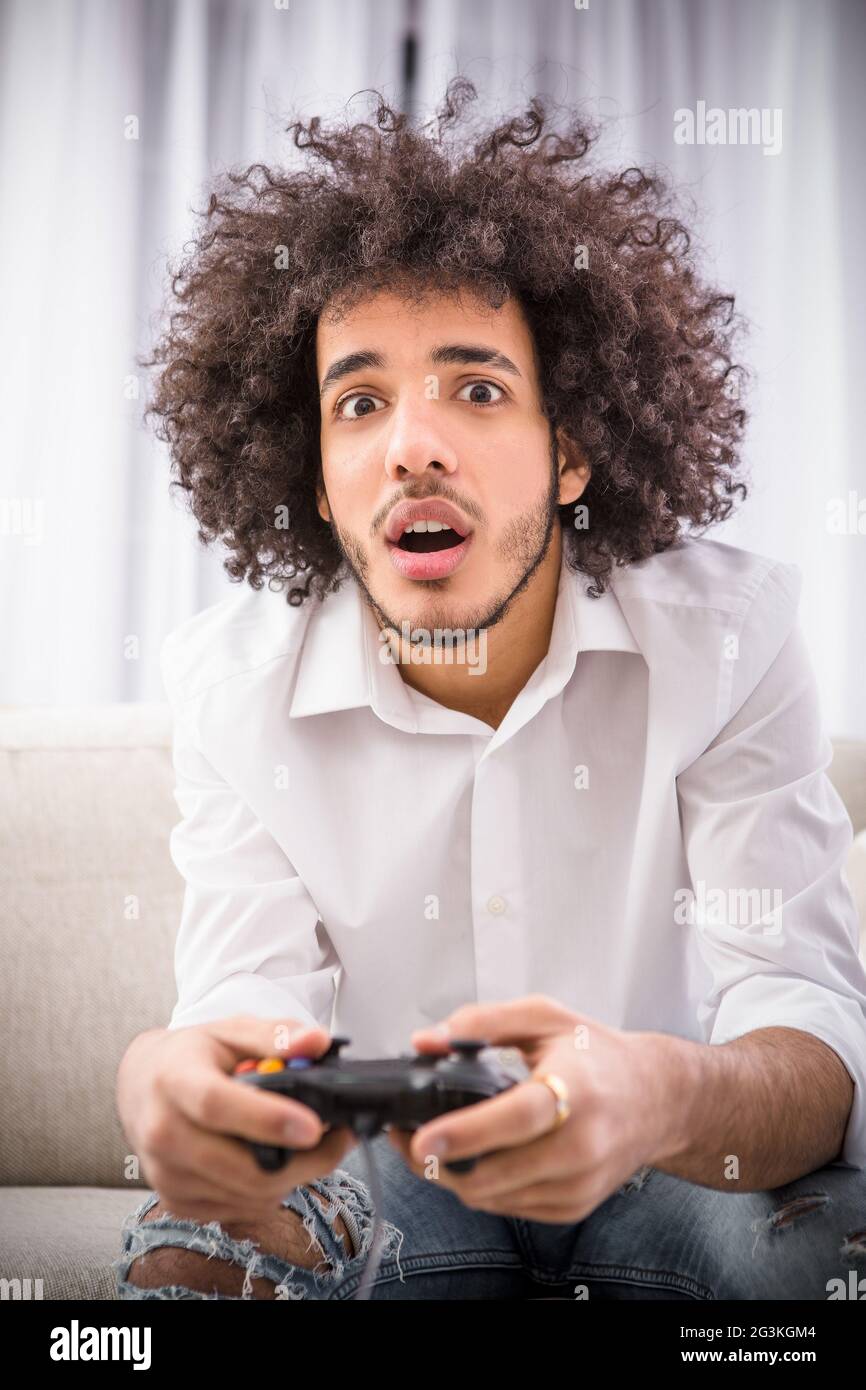 Hipster man playing computer games Stock Photo - Alamy