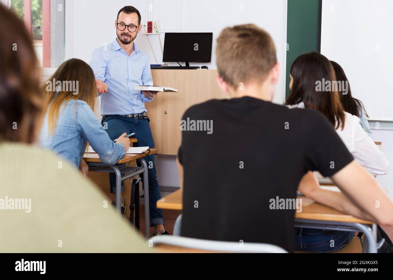 Man teacher giving lecture in classroom Stock Photo - Alamy