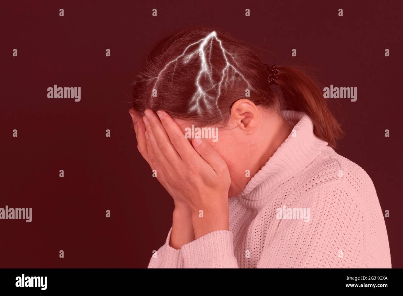 Side shot of young depressed female covering her face with hands ...