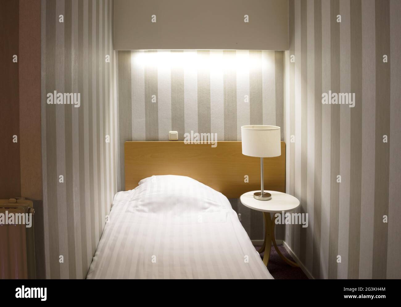 Simple hotel room, single bed Stock Photo - Alamy